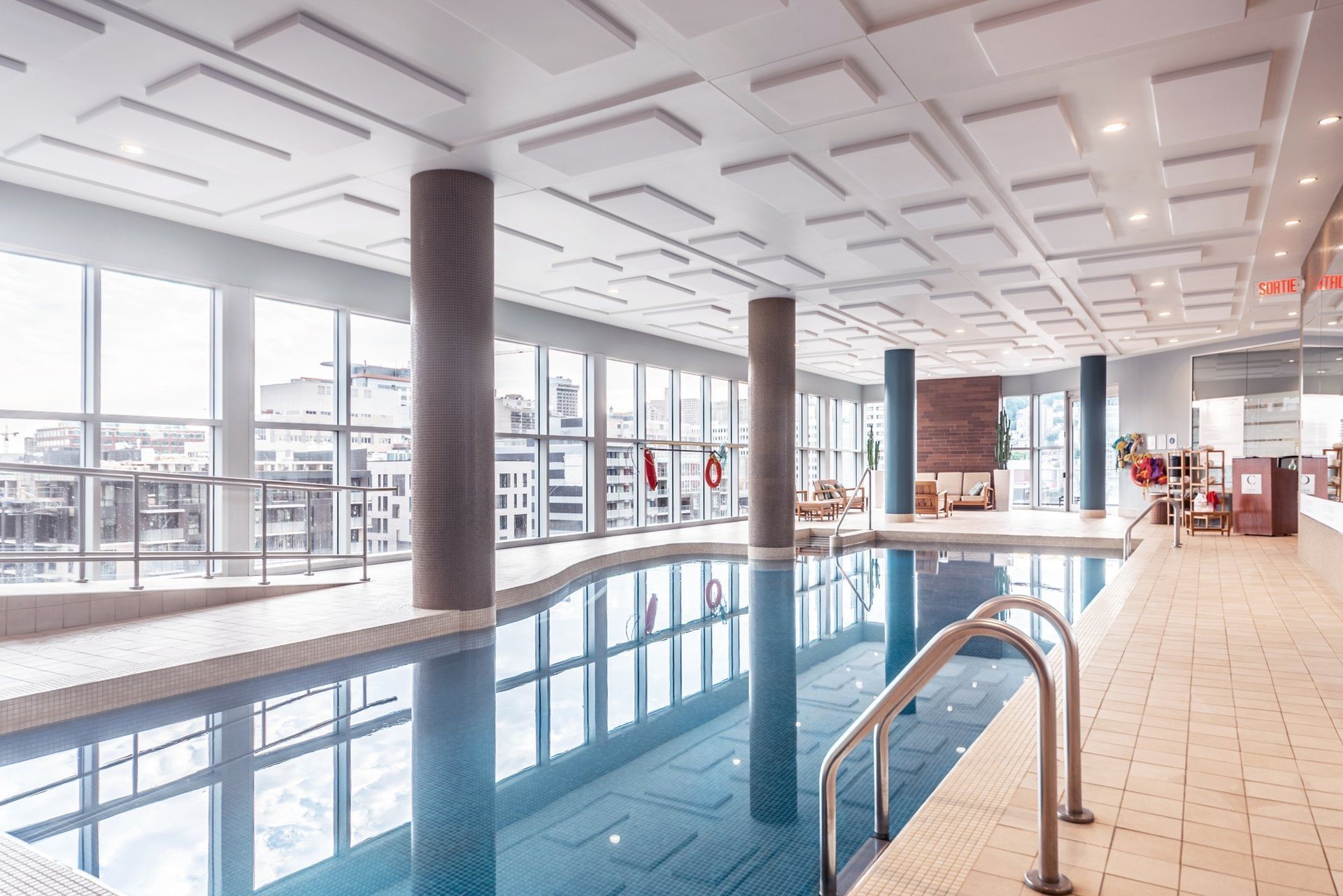 Indoor pool with city view at Warwick Le Crystal - Montreal