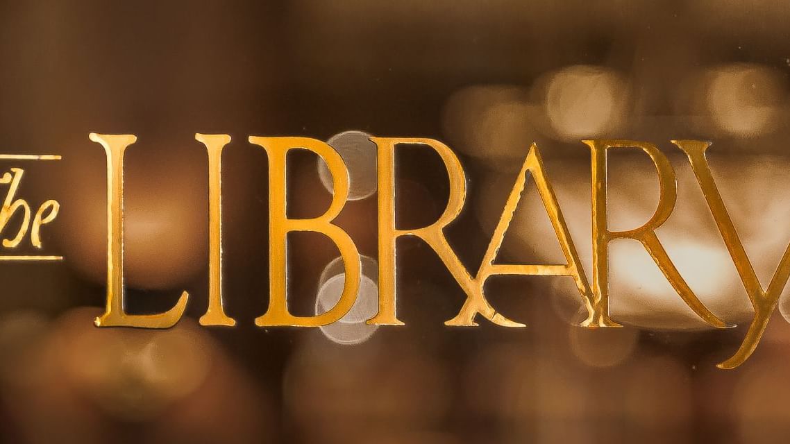 Entrance sign of The Library Bar at Warwick Melrose Dallas