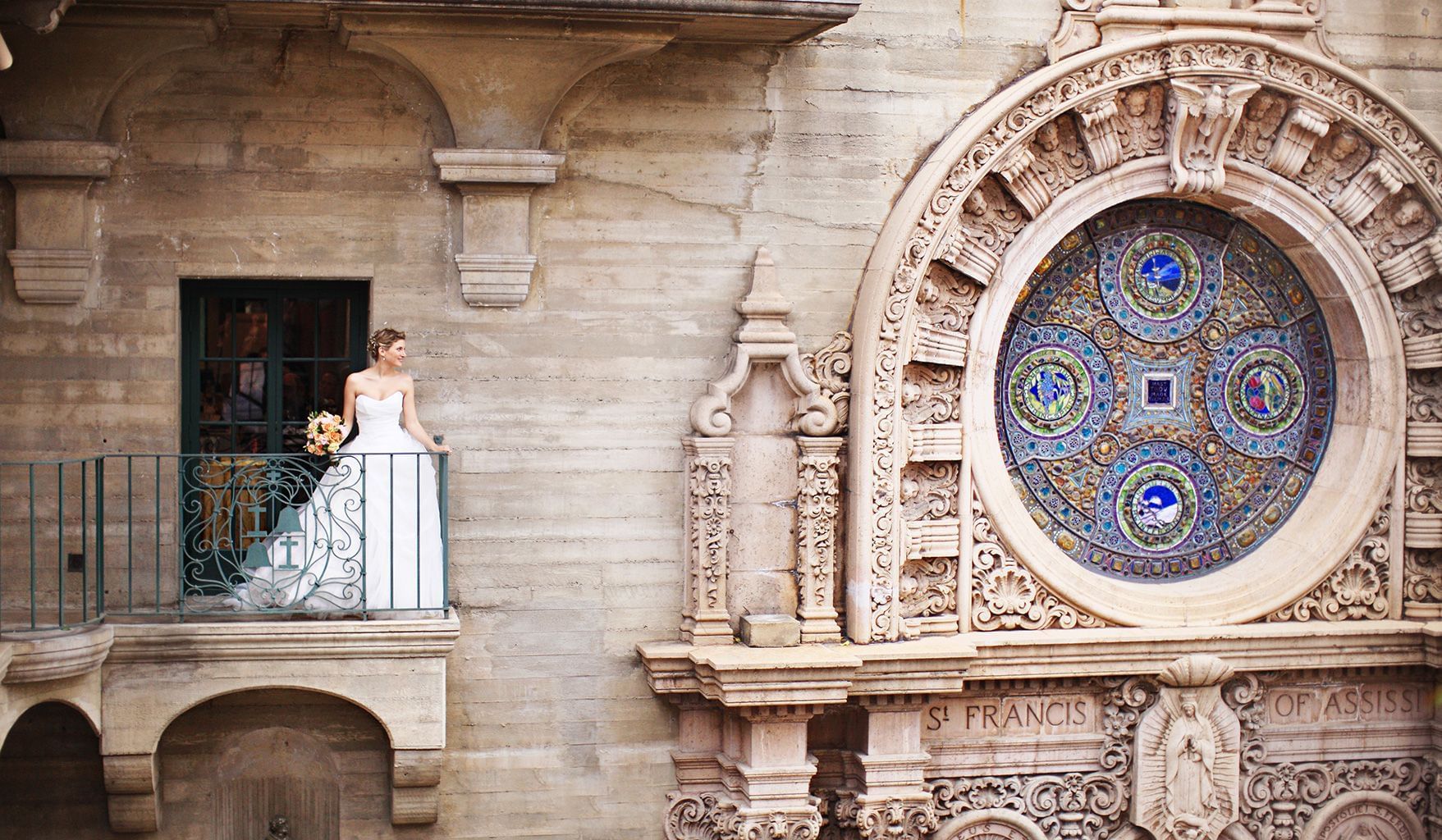 bride on balcony with dress and flowers