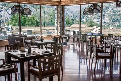 indoor dining area with mountains view at NOI Puma Lodge Hotel